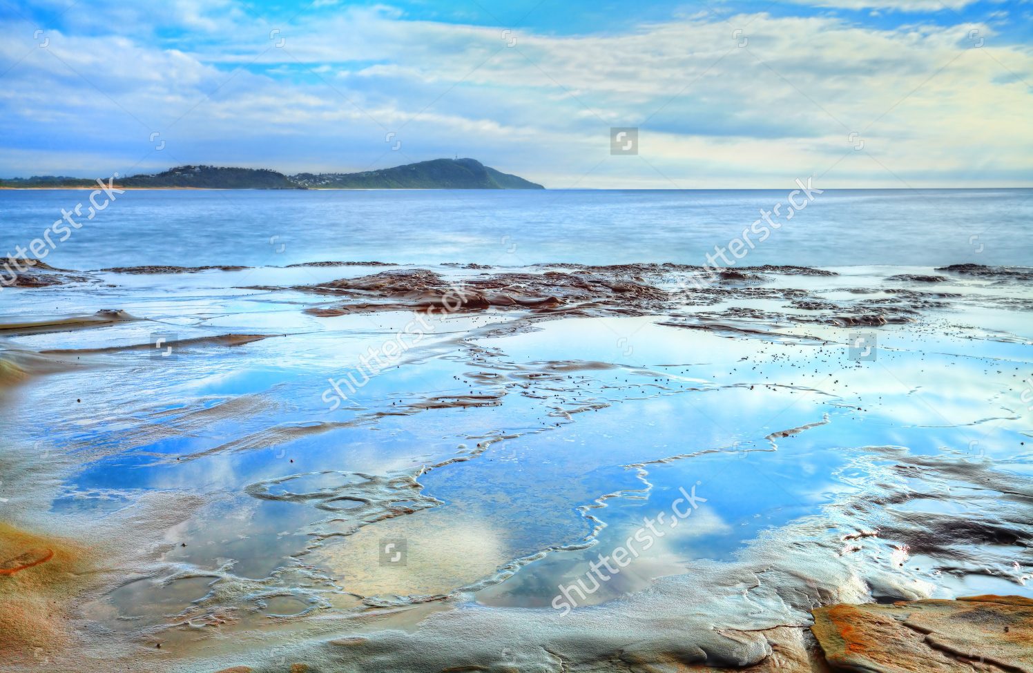 stock-photo-reflections-in-the-shallow-rock-pools-and-lots-of-different ...